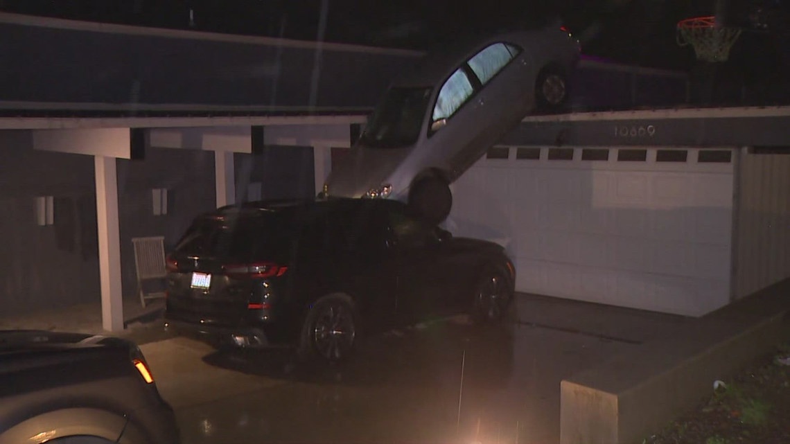 Driver veers off road, crashes car on roof of West Seattle garage ...