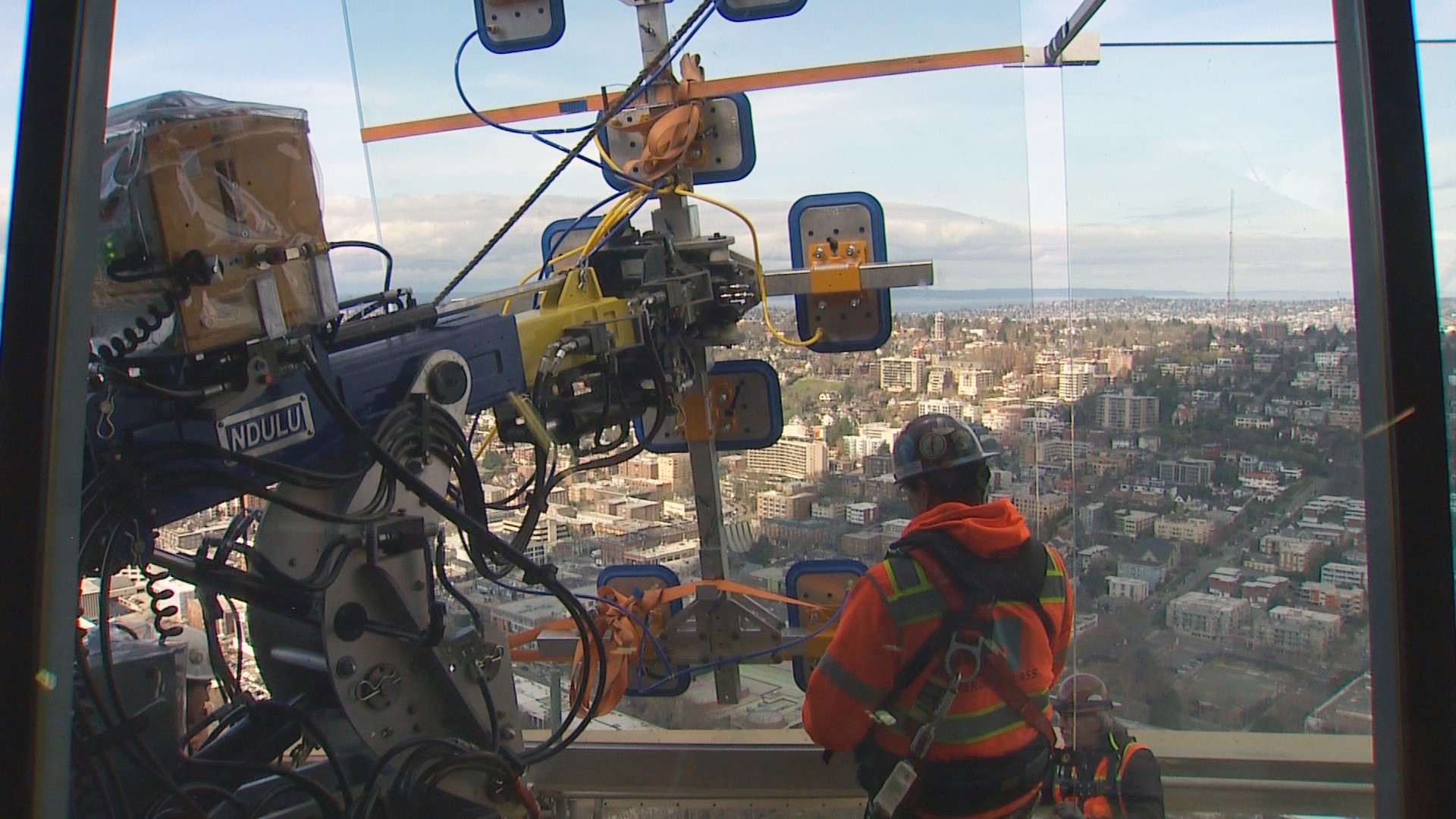 Workers unwrap Space Needle observation deck | king5.com