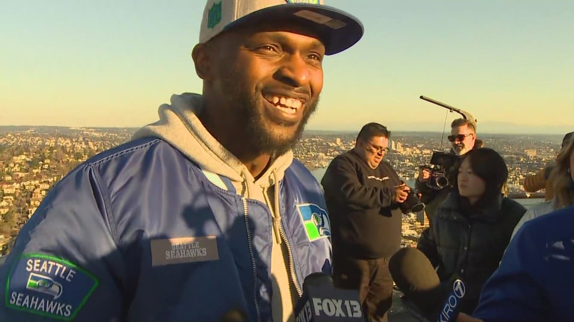 Seahawks legend Cliff Avril raises 12 flag over Space Needle | king5.com