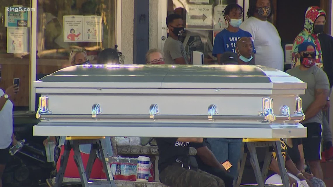 Black activists use casket at Seattle rally to denounce gun violence in ...