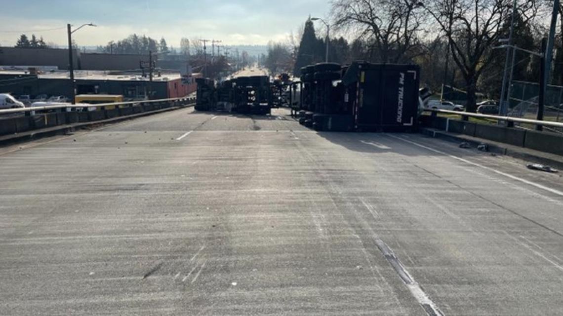 Semi-truck rolls, loses load of aluminum on I-5 off-ramp in Seattle | king5.com
