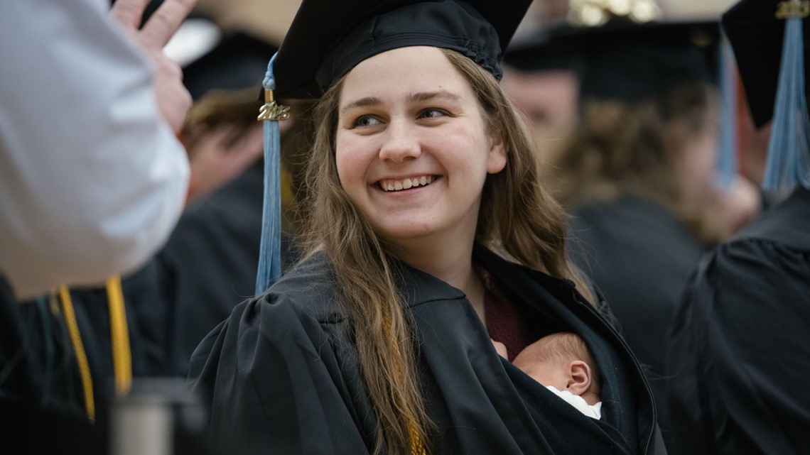 Woman walks in graduation with newborn baby | king5.com